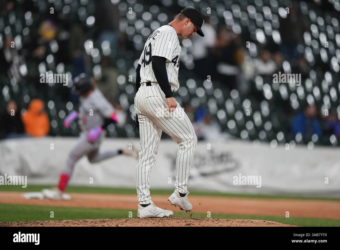 Chicago White Sox relief pitcher Jordan Leasure kicks the mound after ...