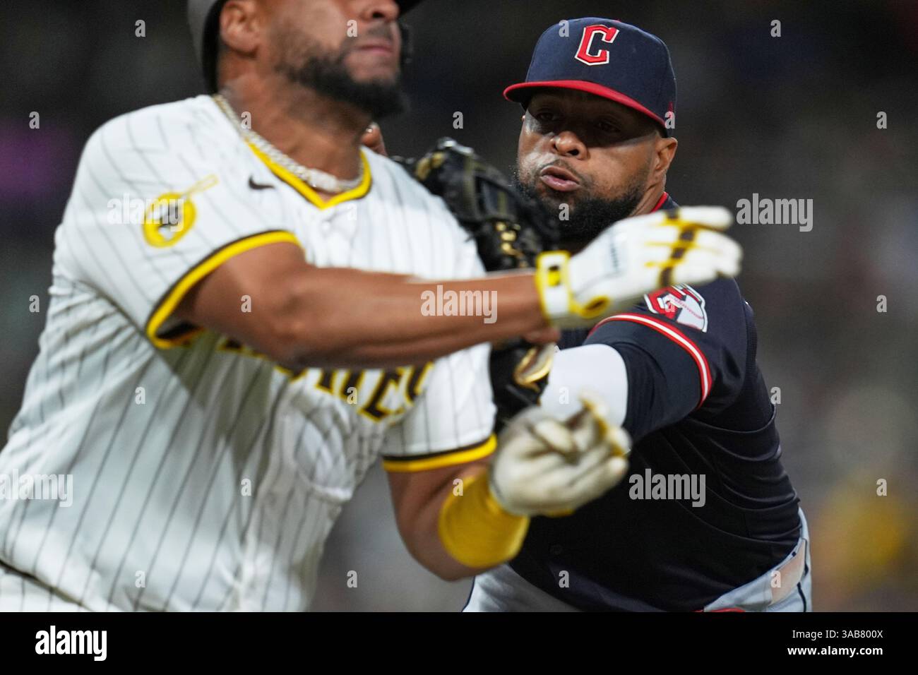 Cleveland Guardians first baseman Carlos Santana, right, tags out San ...