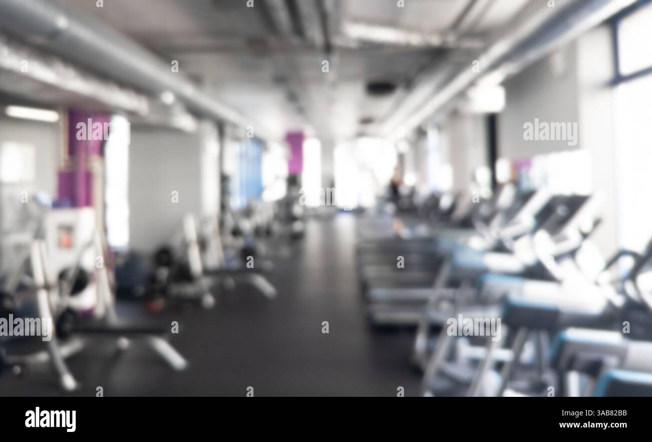 Blurred background with fitness gym people cardio workout in sport club ...