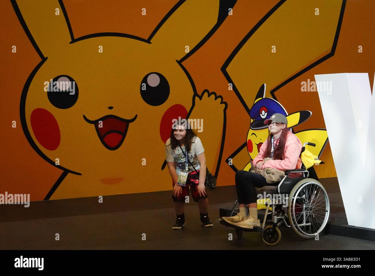 Visitors are seen gesturing in front of the Pikachu decoration. London ...