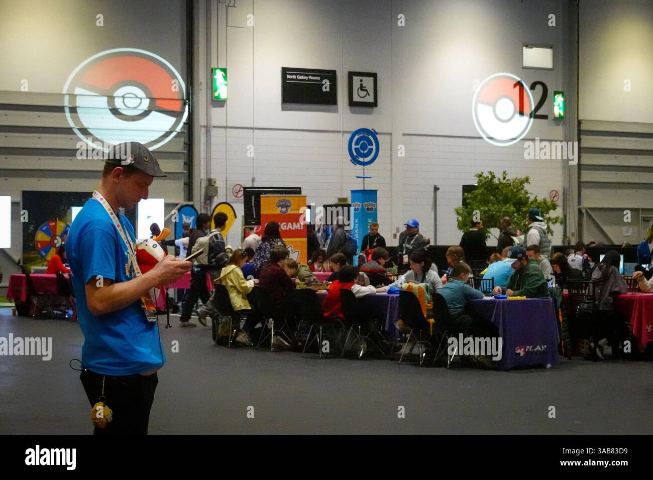 Competitors are playing card games, or known as the Pokemon Trading ...