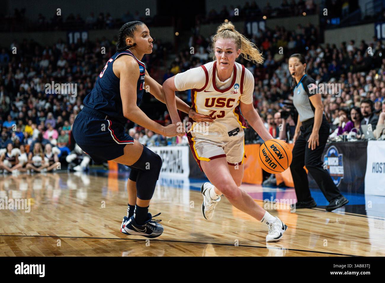USC Trojans guard Avery Howell (23) is defended by UConn Huskies guard ...