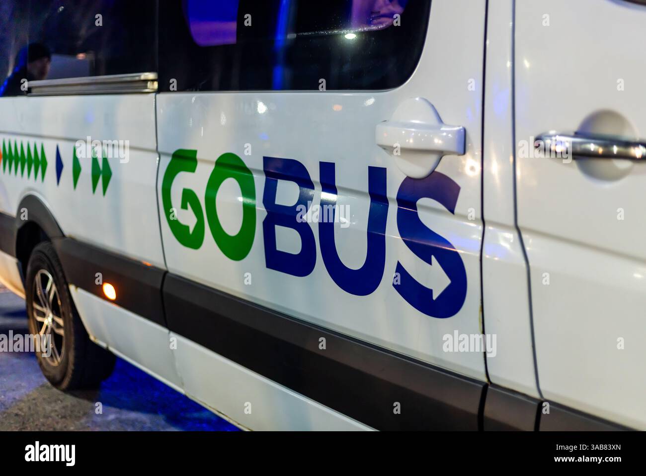 Logo GoBus on side of shuttle bus in Manas airport at night Stock Photo - Alamy
