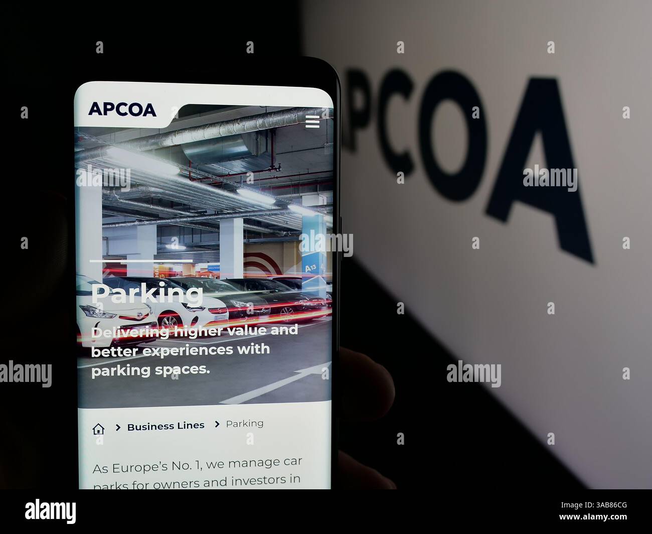 In this photo illustration, a person is holding a web page with the ...