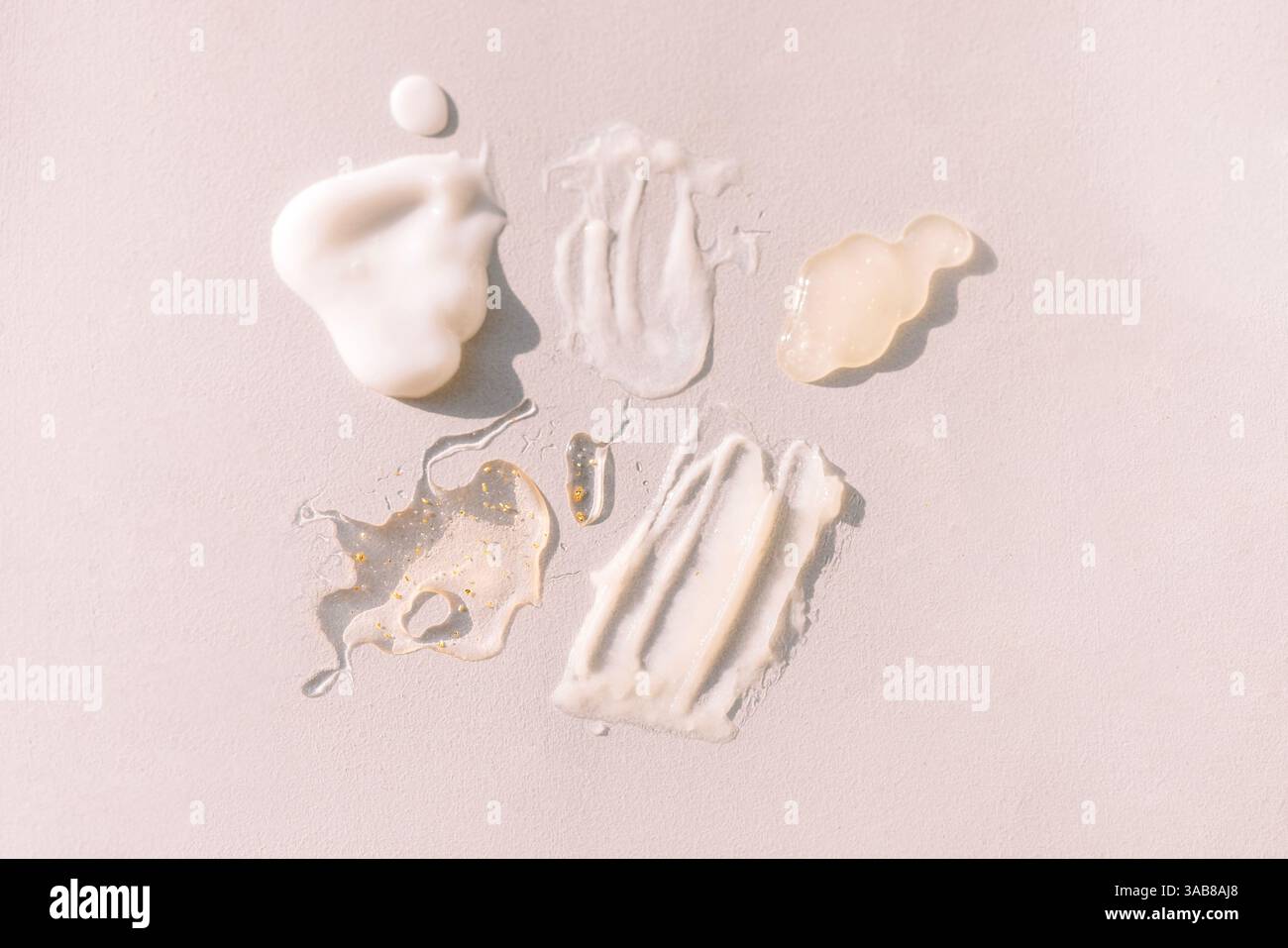 A collection of different lotions and creams are spread out on a table ...