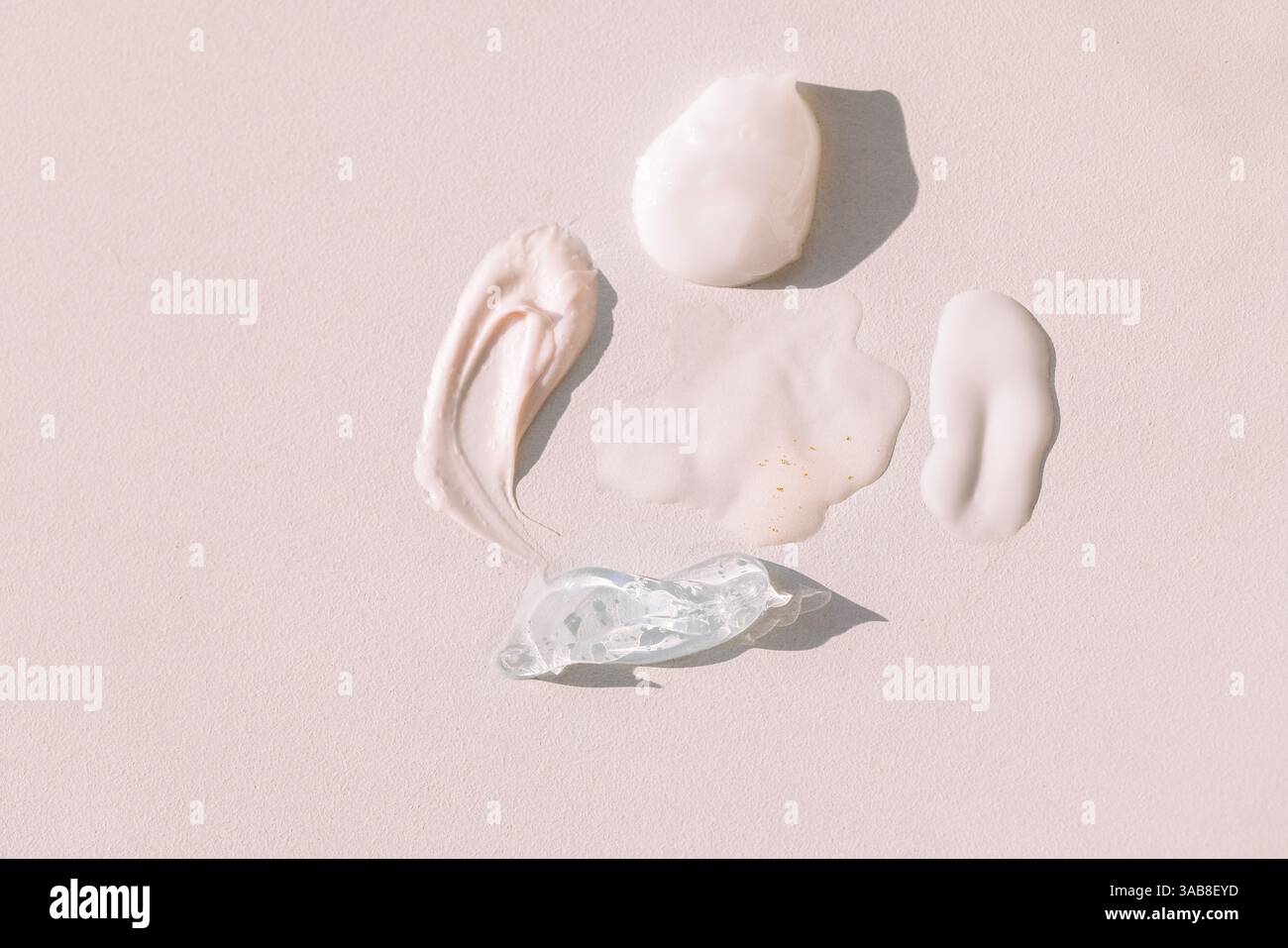 A collection of different lotions and creams are spread out on a table ...