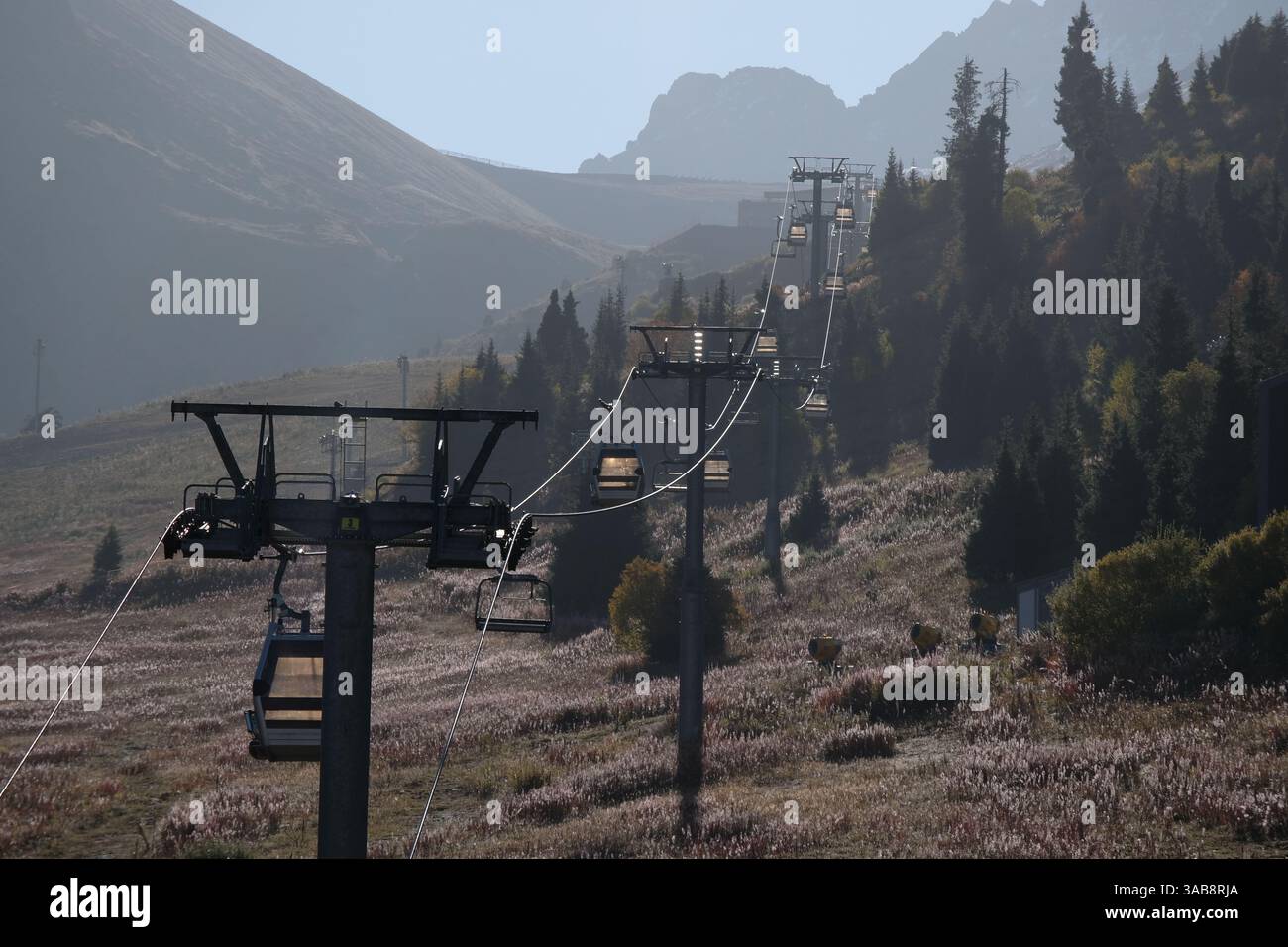 Cable car among the mountains and hills of Shymbulak Stock Photo - Alamy
