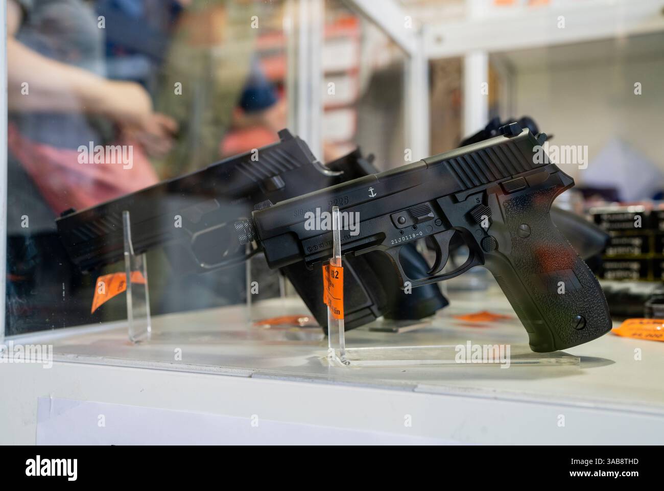Semi-automatic pistols Sig Sauer in gun display case in firearms store ...