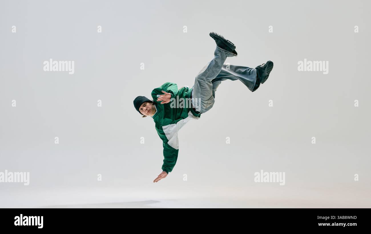 Young hip-hop dancer, dressed retro jacket and pants, performing ...