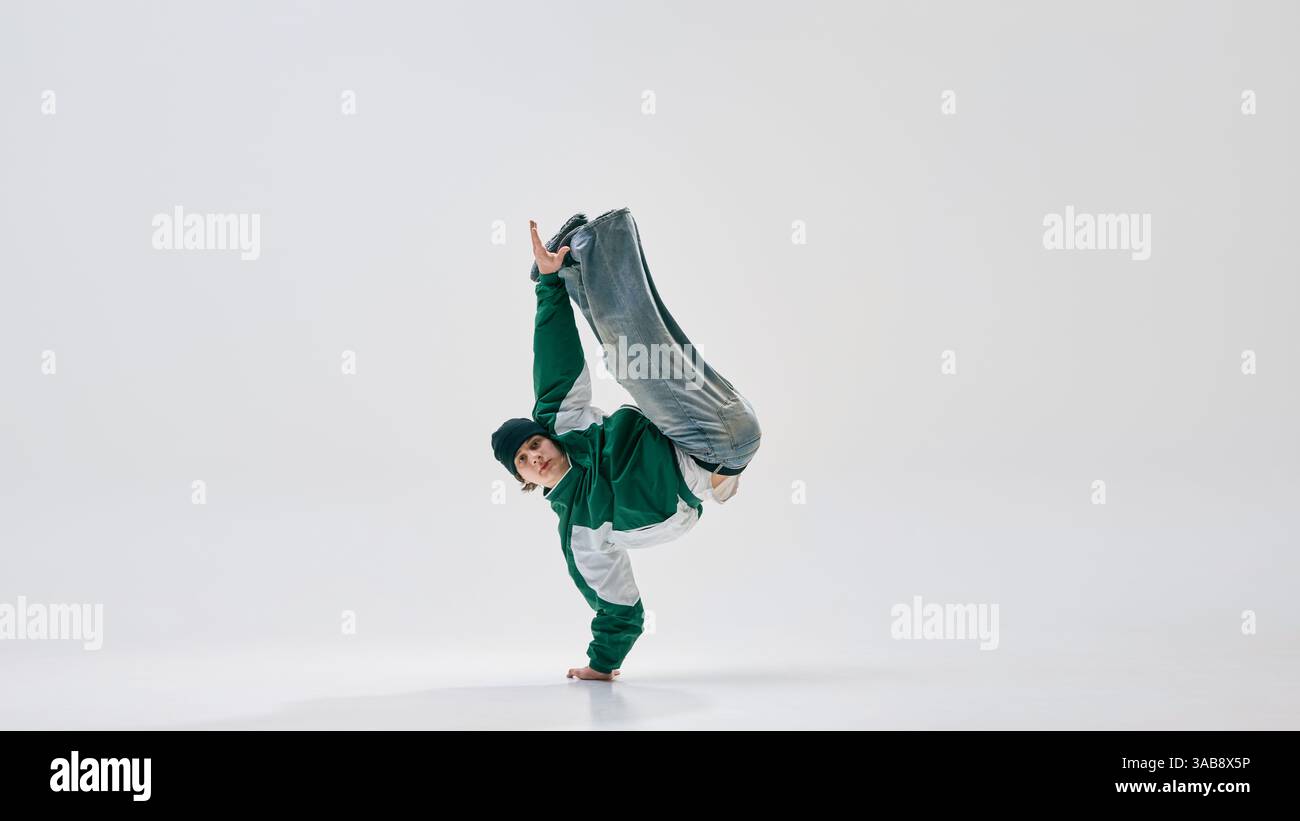 Performer, dressed retro attire, striking dynamic one-handed pose with ...