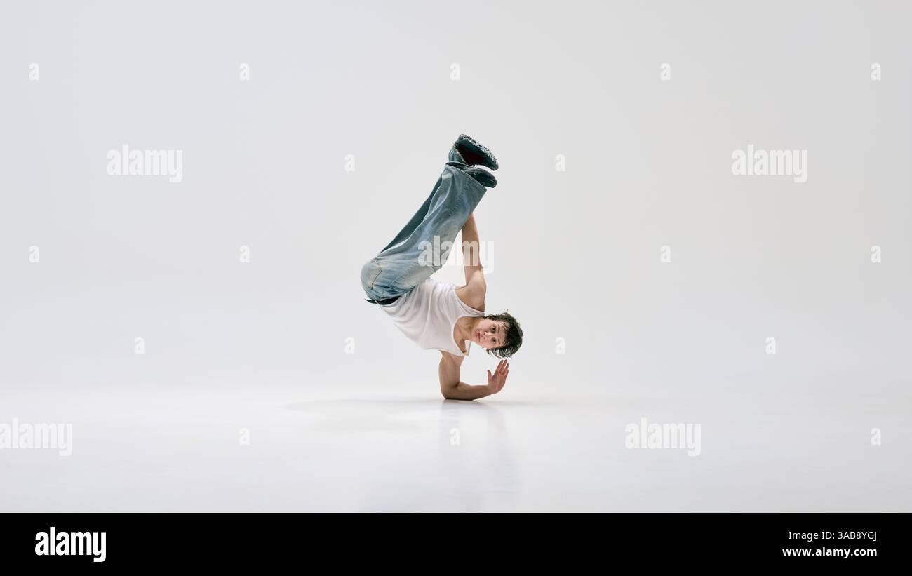 Talented hip hop dancer, dressed casual attire, lifting body into ...