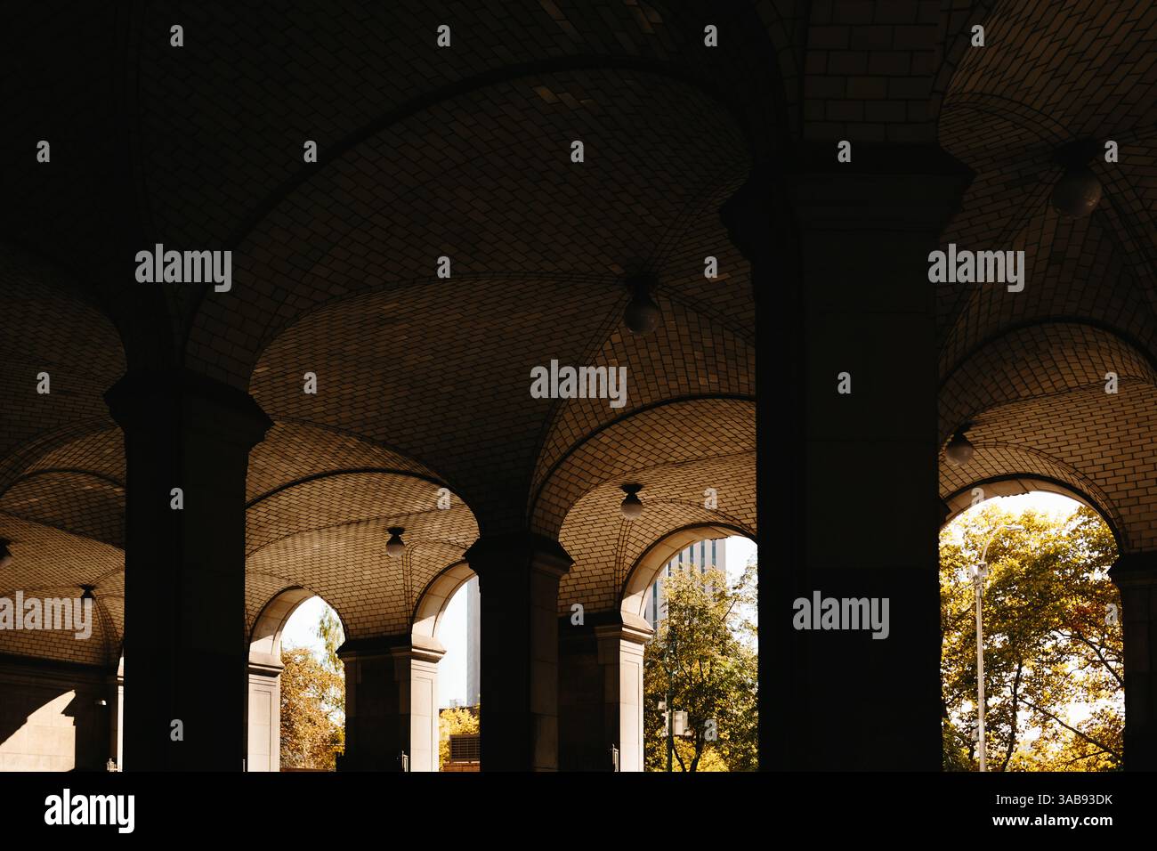 This photo captures a series of dimly lit arches and columns ...