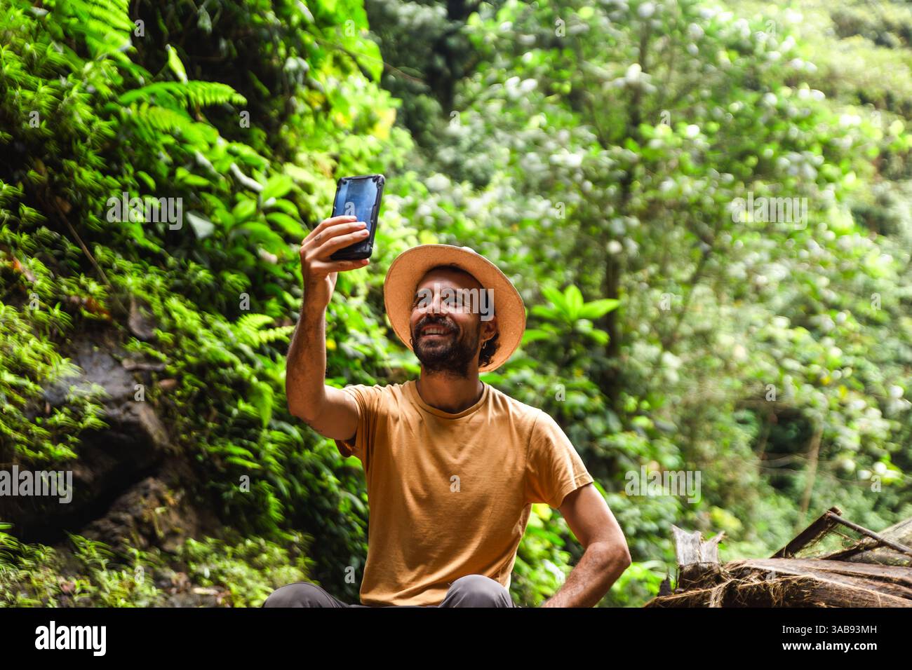 A young man smiling while taking a selfie in the Choco Andino ...