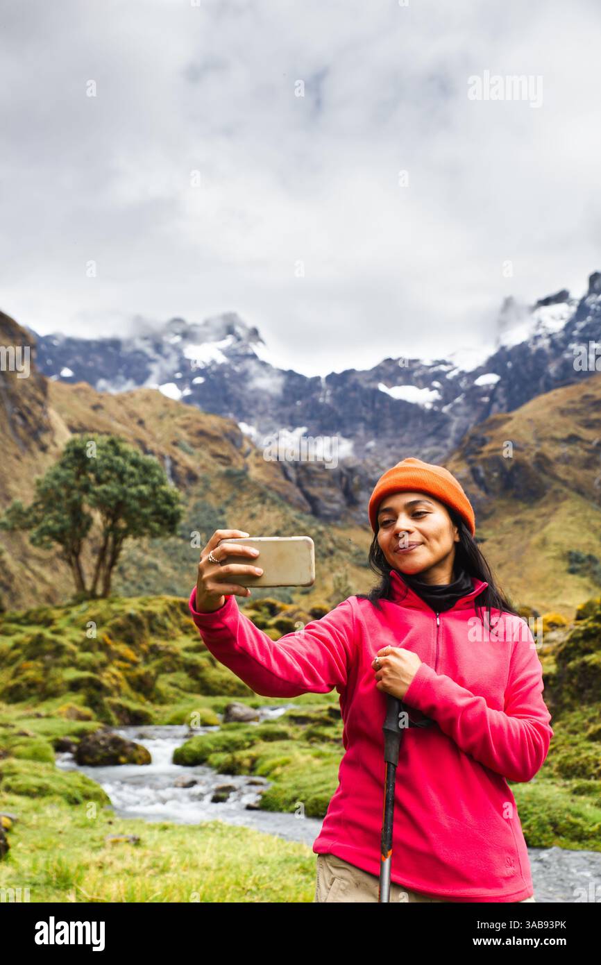 Ecuadorian woman takes a selfie against the backdrop of El Altar ...