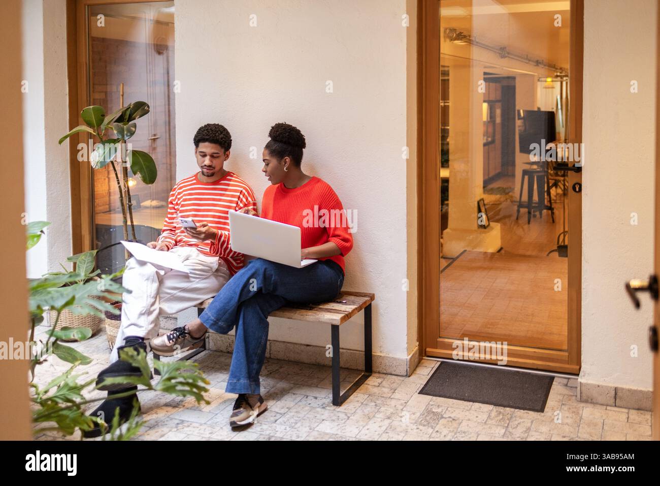 Two colleagues engage in collaborative hi-res stock photography and ...