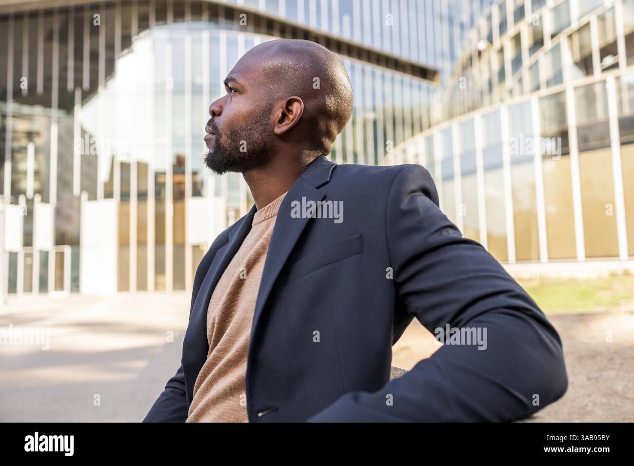 A thoughtful business cuban man in a navy suit gazes into the distance ...