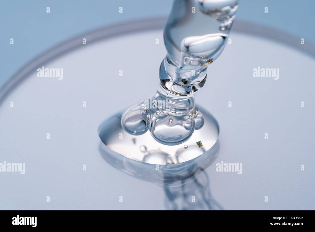 Close-up image capturing the delicate movement of a clear, viscous ...