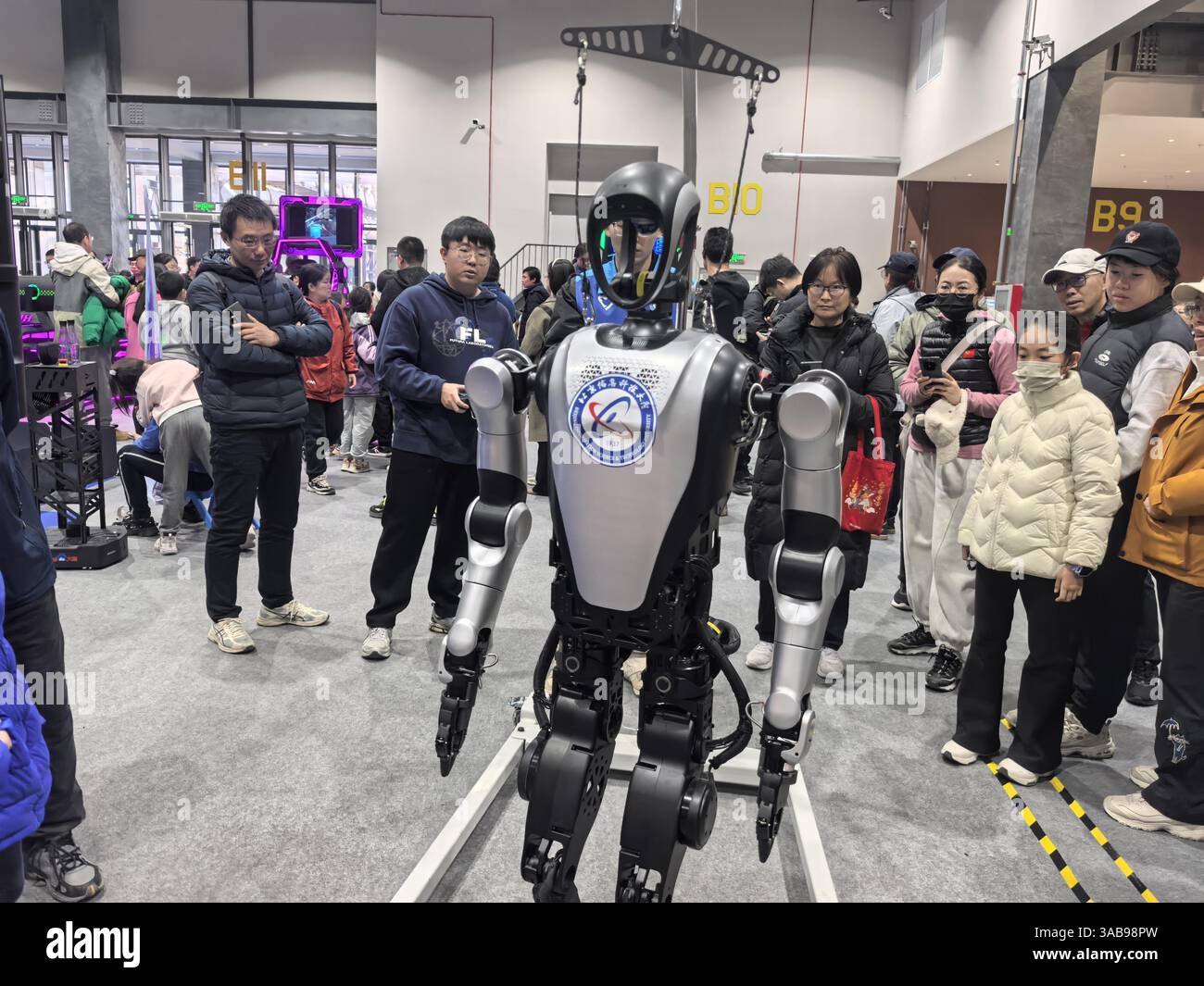 People interact with a humanoid robots in Beijing, China, 29 March ...