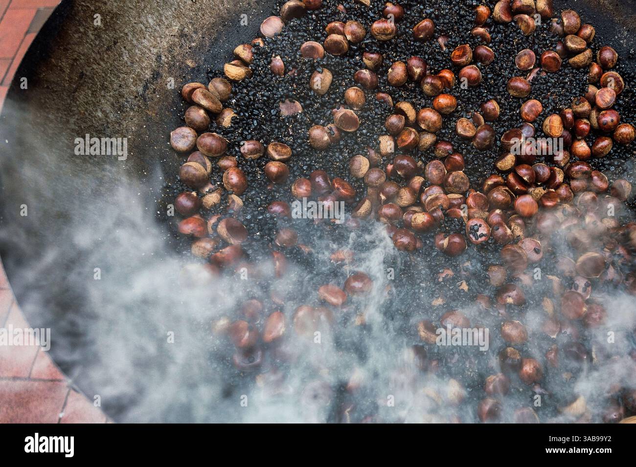 Vendor roasting chestnuts in bustling hi-res stock photography and ...