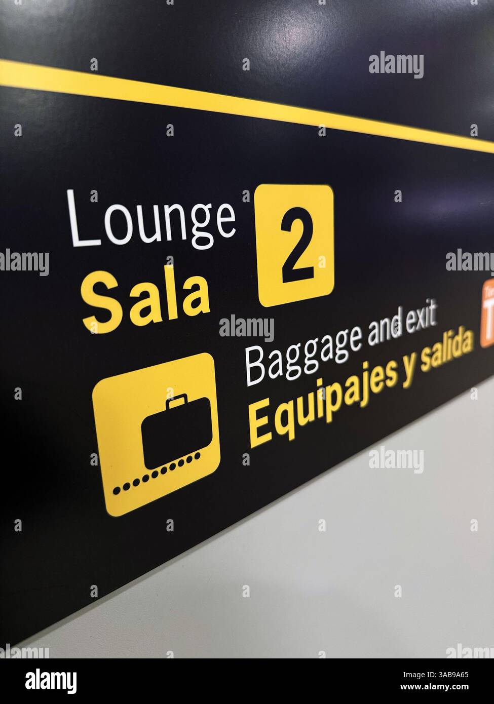 Airport sign with directions in English and Spanish, guiding travelers ...