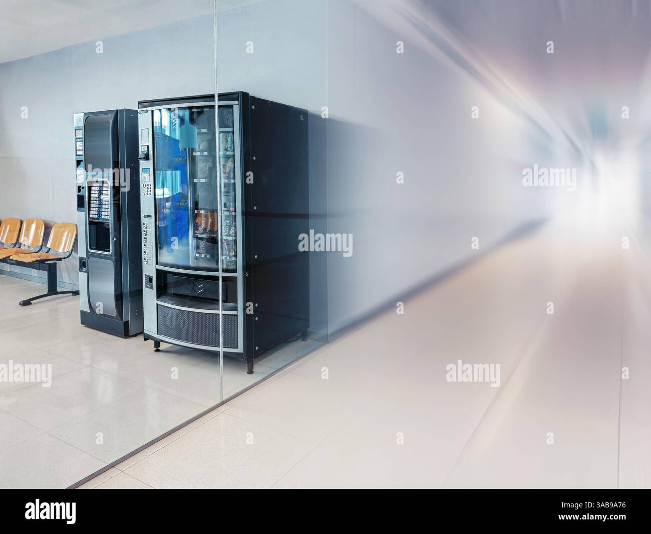 A sleek, modern corridor with vending machines and seating. The vending ...