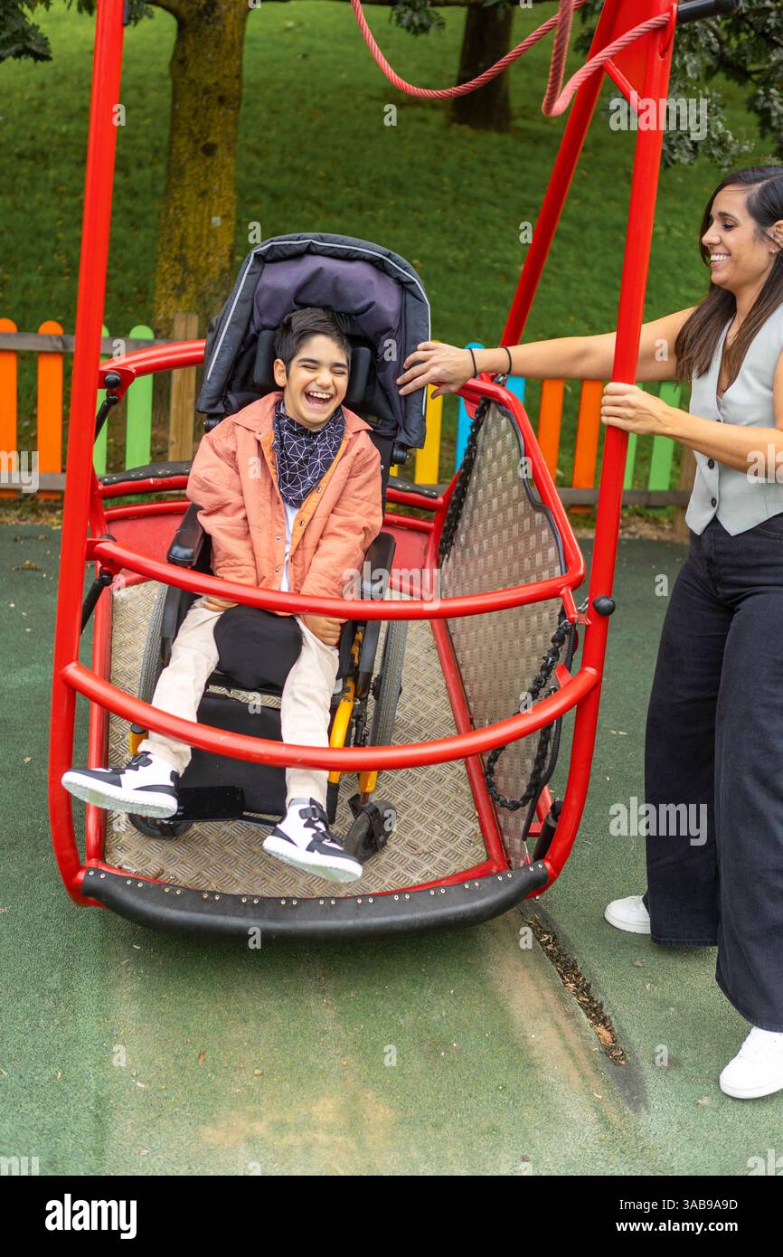 A child with cerebral palsy in a wheelchair enjoys an inclusive ...