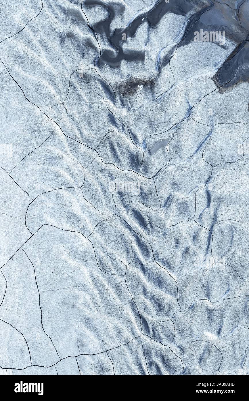 A striking aerial view of icy terrain showcasing natural patterns and ...