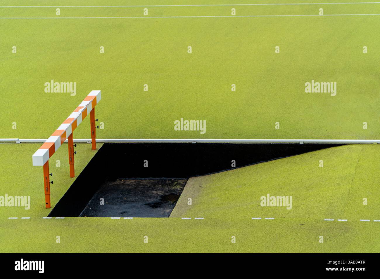 A bright view of a water jump section for the steeplechase race in an ...