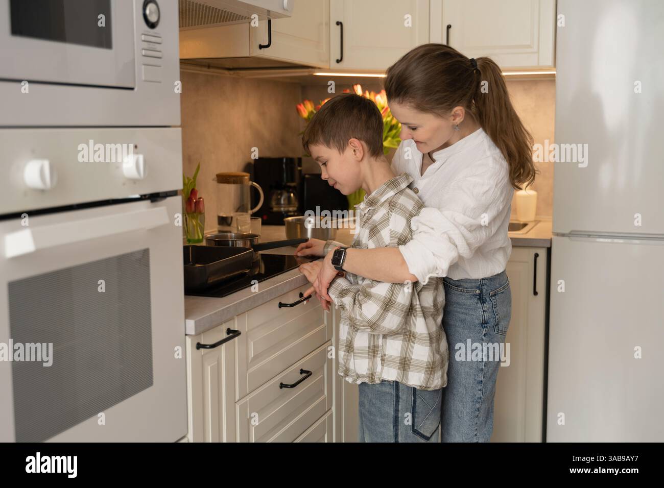 A mother and son share a heartwarming moment while cooking together in ...