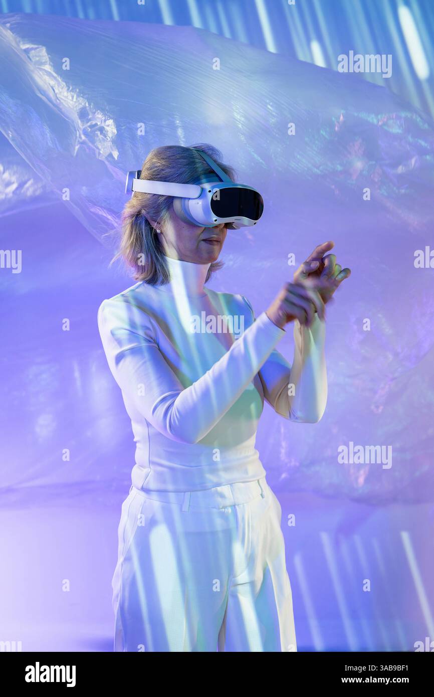 An elderly Asian woman engaging with the metaverse, wearing a VR ...