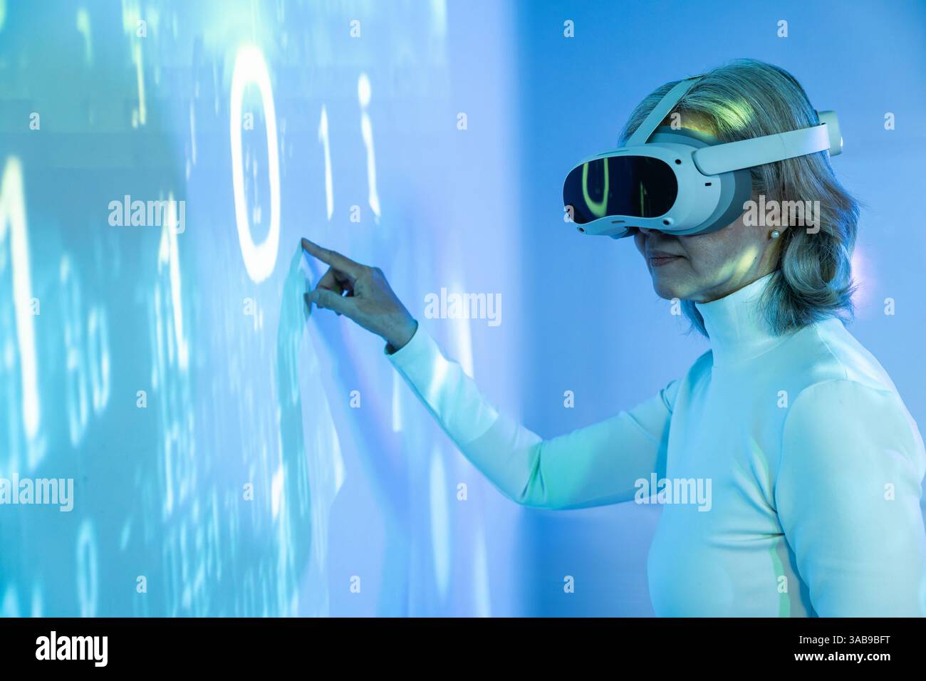 An elderly Asian woman wearing a VR headset interacts with a virtual ...