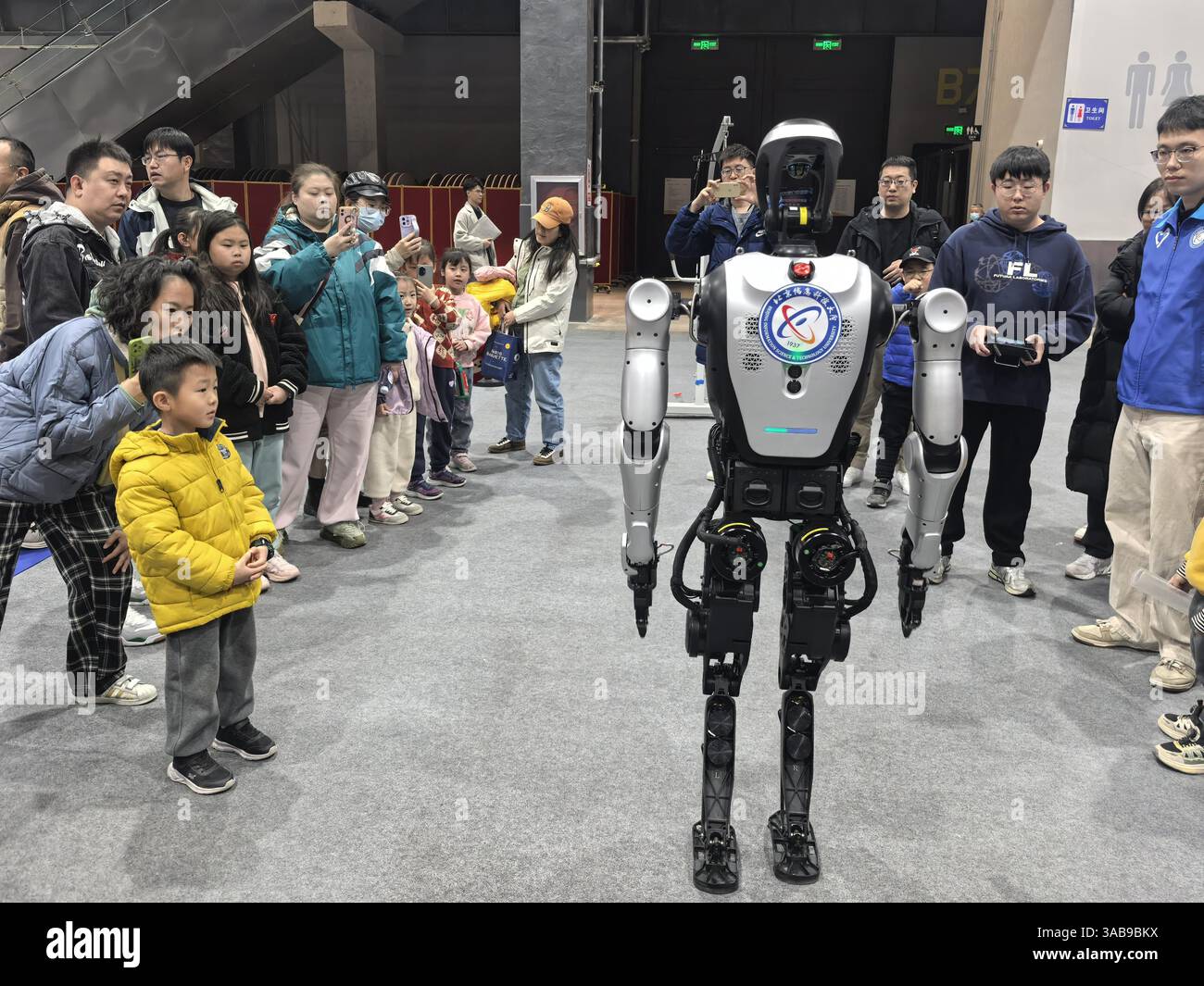 People interact with a humanoid robots in Beijing, China, 29 March ...