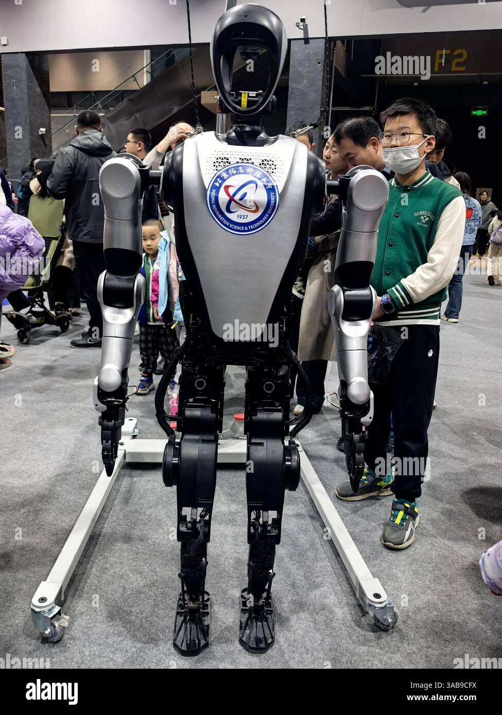 People interact with a humanoid robots in Beijing, China, 29 March ...