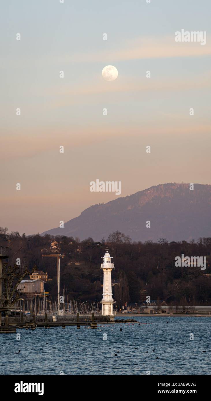 A serene evening in Geneva with a full moon above a historic lighthouse ...