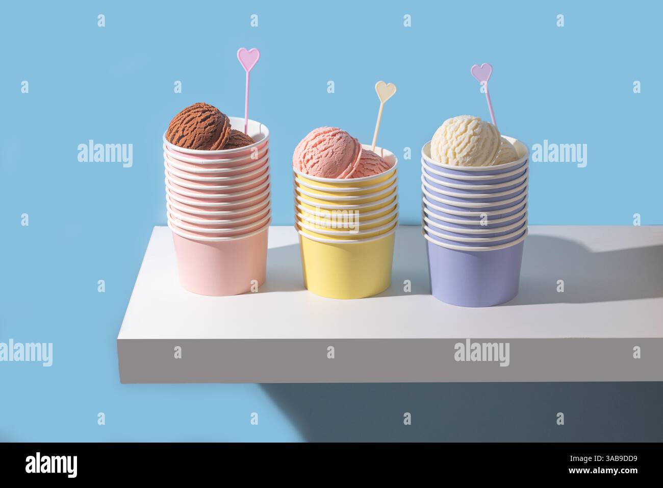 A minimalist presentation of chocolate, strawberry, and vanilla ice ...