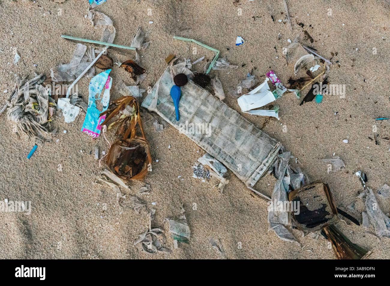 Litter scatters across a beach in Bali, Indonesia, highlighting the ...