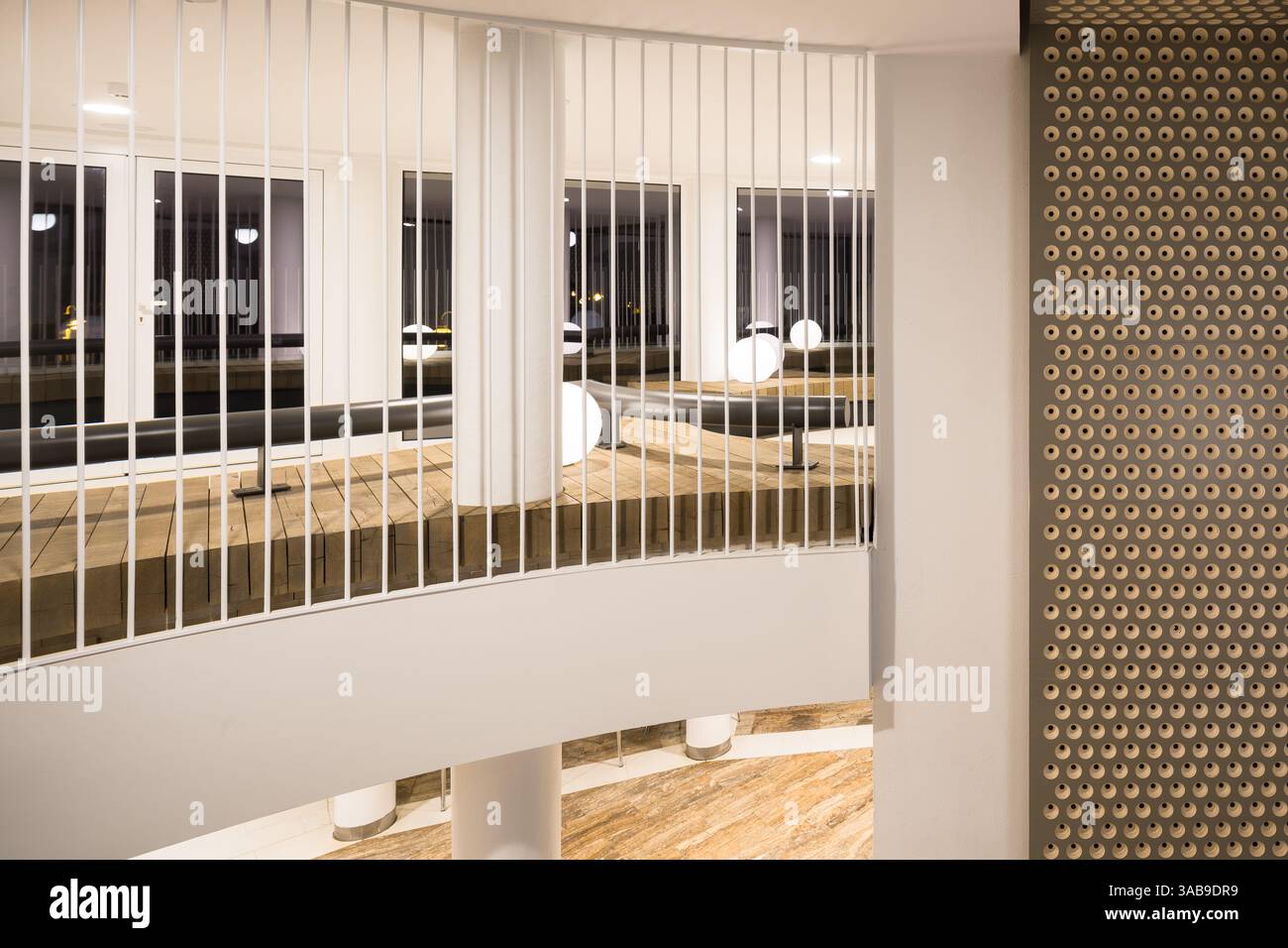 A modern club interior space featuring wooden flooring, decorative ...