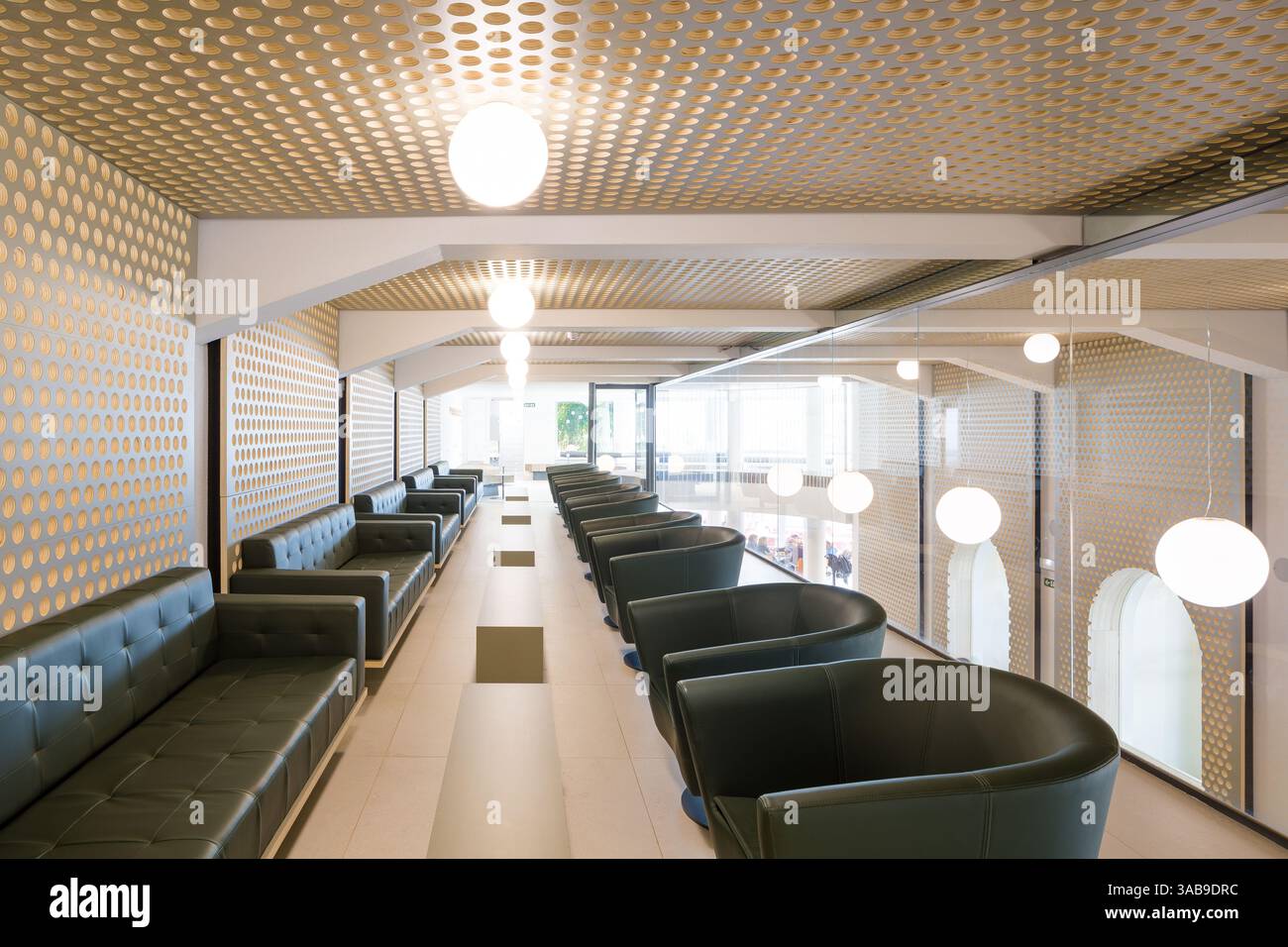 A contemporary lounge in club features stylish seating and a ...