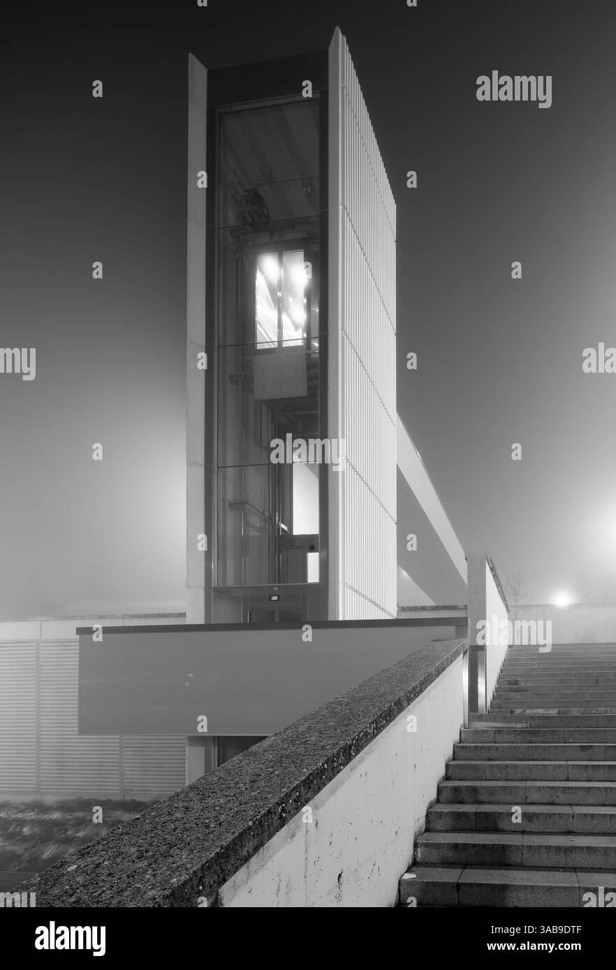 A striking image of a modern urban elevator enveloped in heavy mist ...