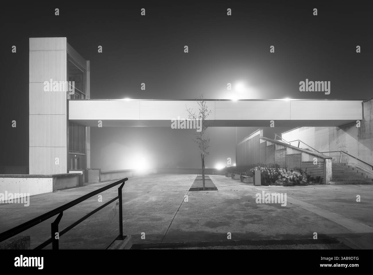 A quiet, atmospheric urban landscape featuring a modern elevator ...