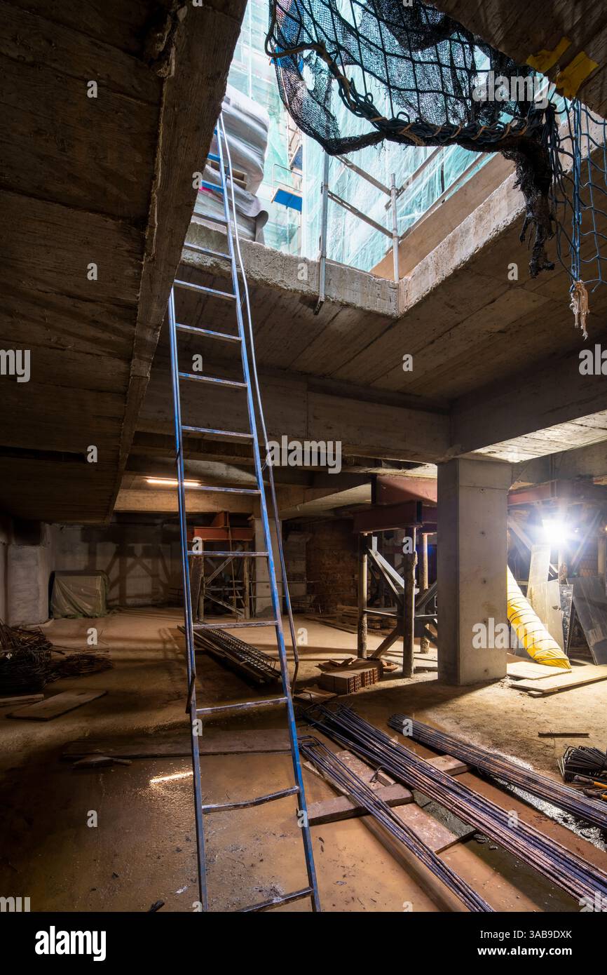 An indoor construction site with essential elements like ladders ...