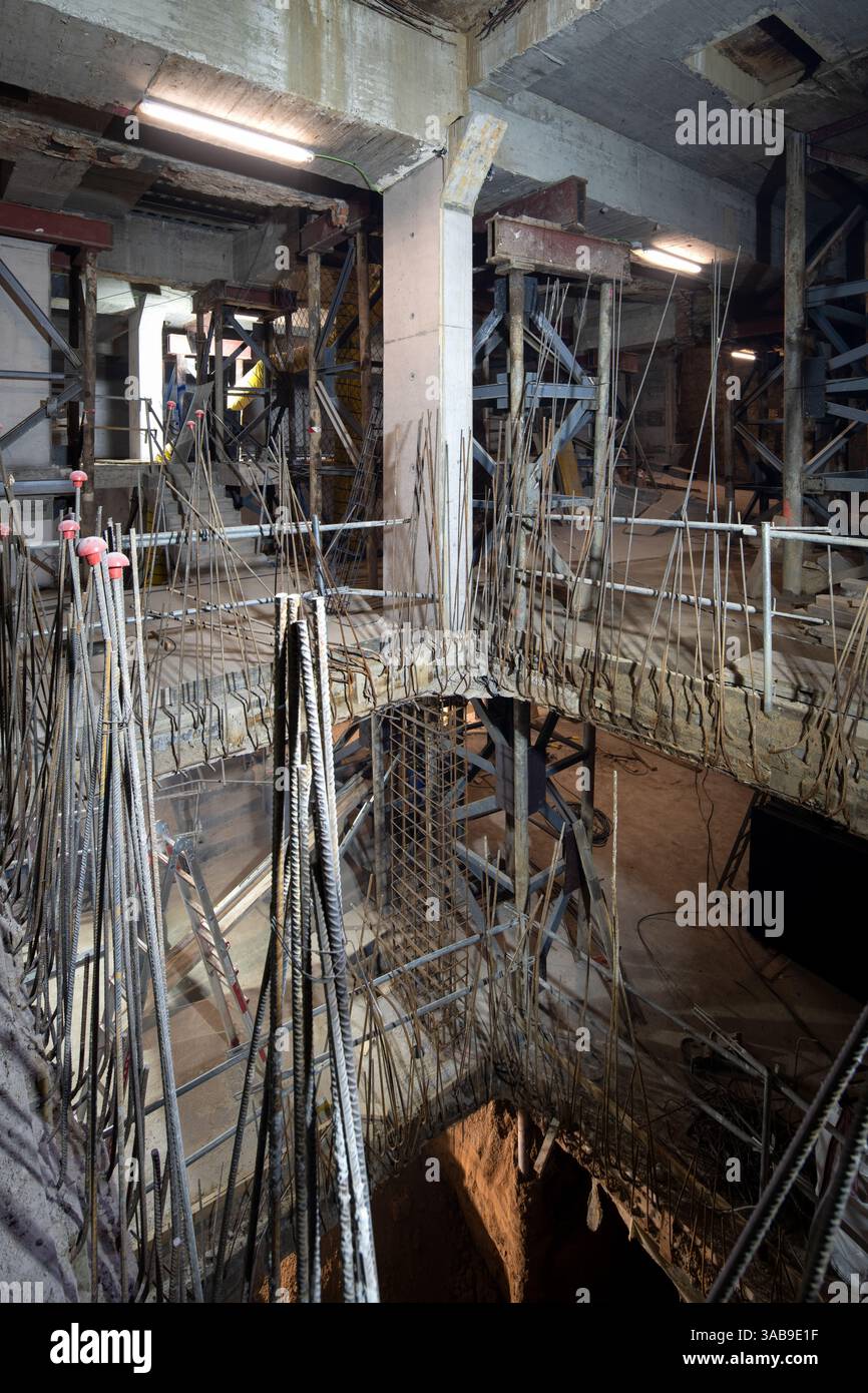 Interior view of a construction site featuring exposed steel ...