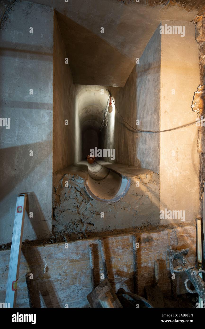 A partially constructed underground tunnel with visible concrete ...
