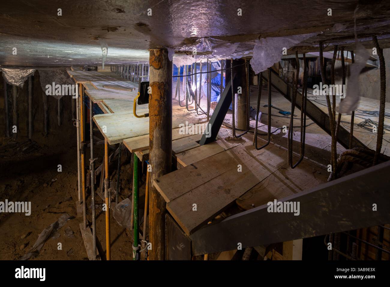 A detailed view of an underground construction site reveals complex ...