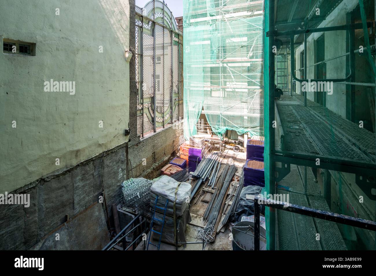 A construction site with scaffolding and building materials like metal ...