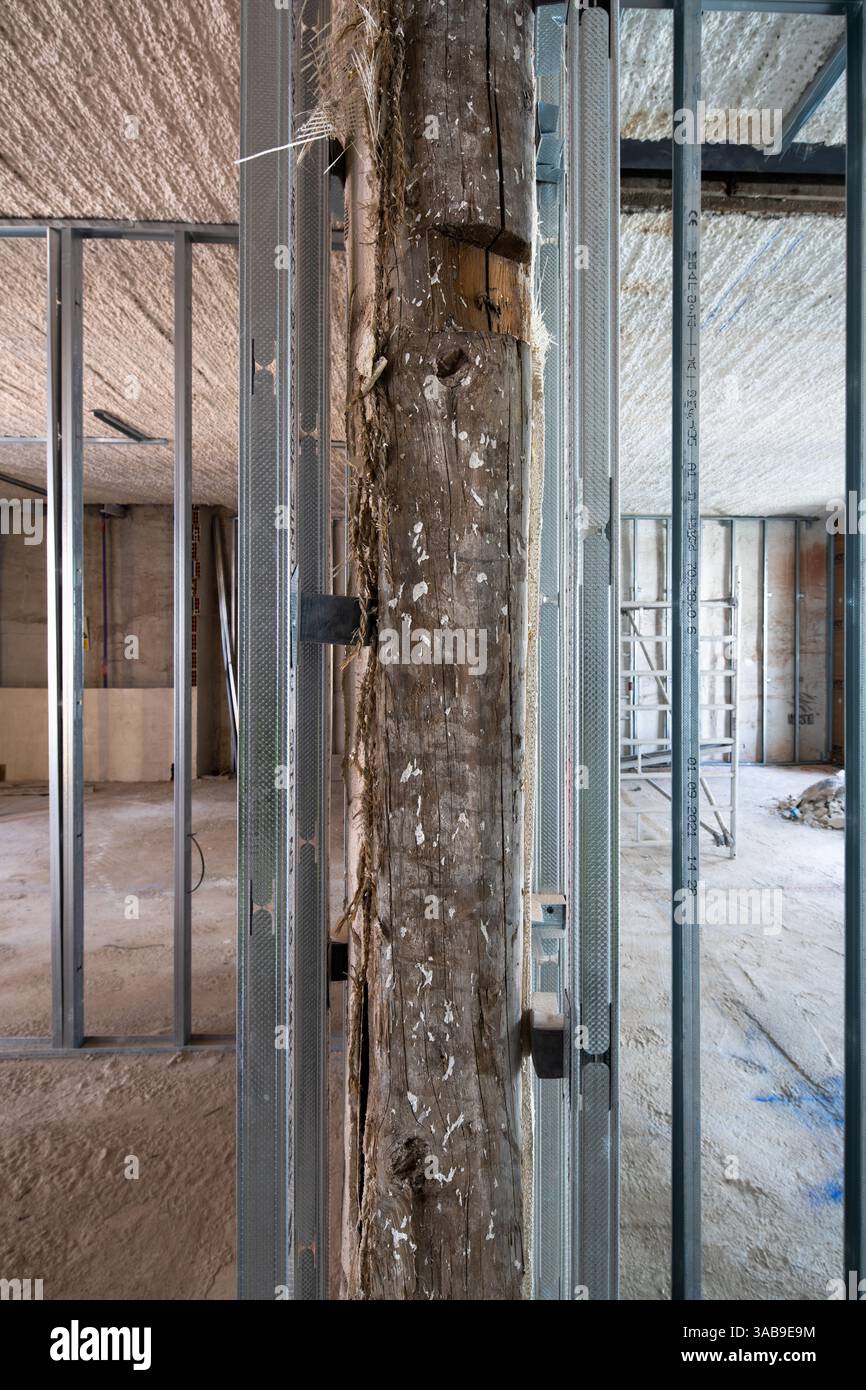 Image of a construction site featuring exposed metal framing, a wooden ...