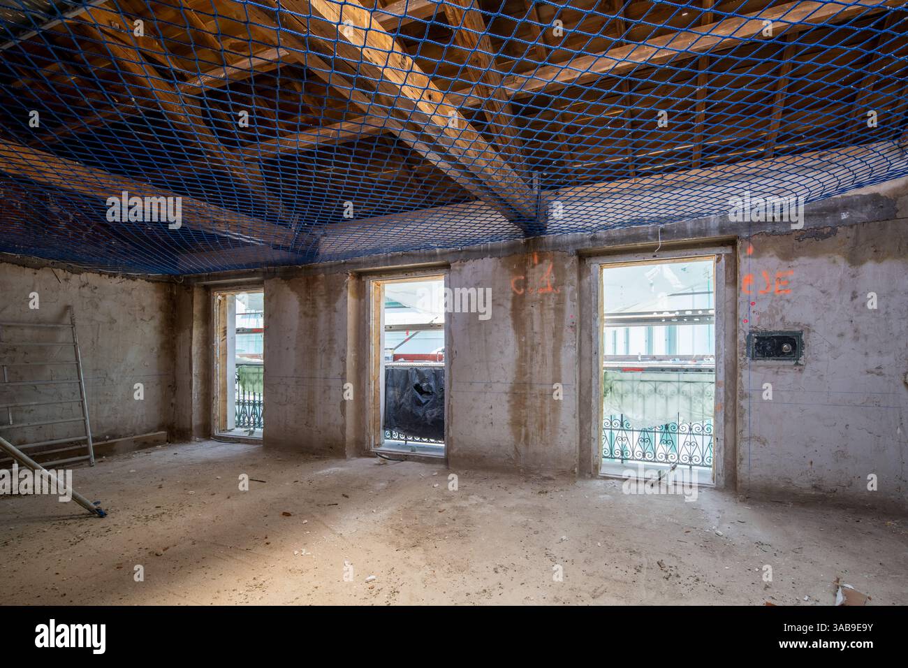 Interior of a construction site showing exposed wooden beams and safety ...