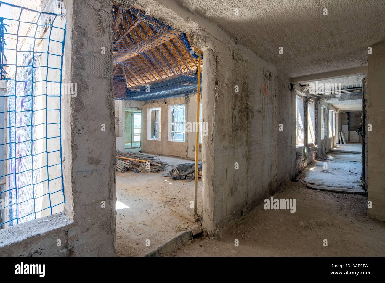 Interior view of a construction site showing exposed concrete walls and ...