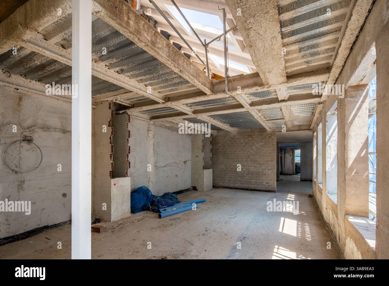 A spacious interior construction site featuring exposed metal framework ...