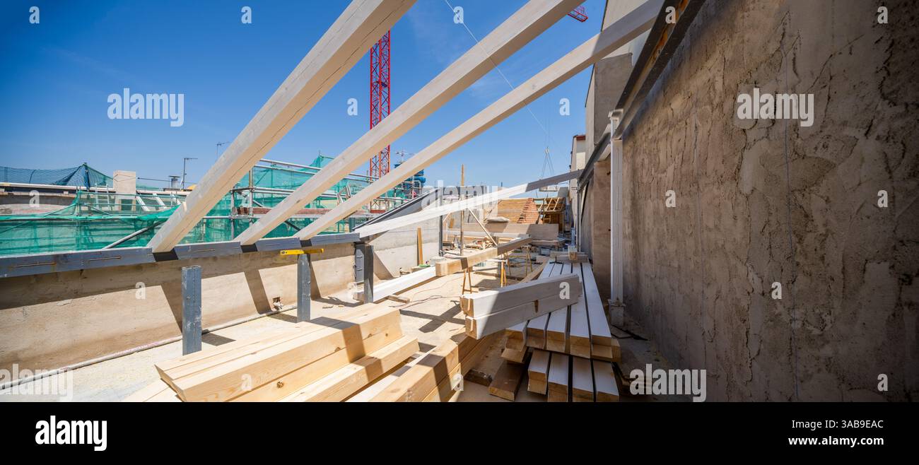 A construction site features exposed wooden beams and various building ...